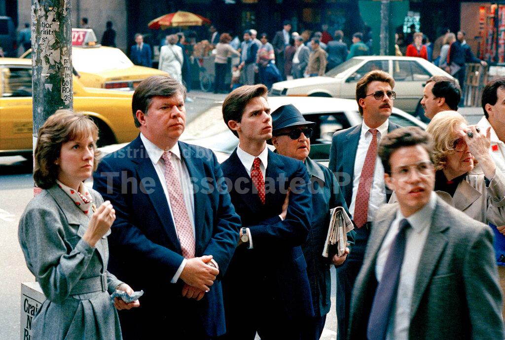 Passers-by watch the ticker on 42nd Street at Grand Central Station in ...