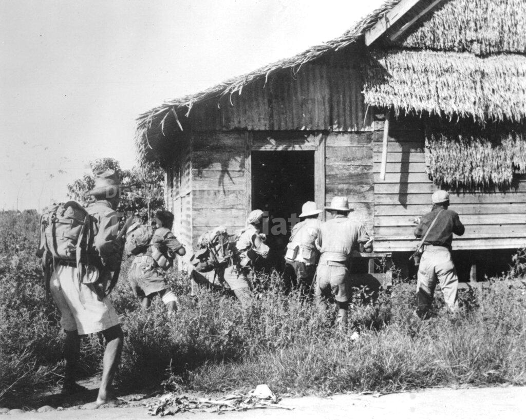 Filipino guerrilla fighters are seen as they close in on Japanese ...