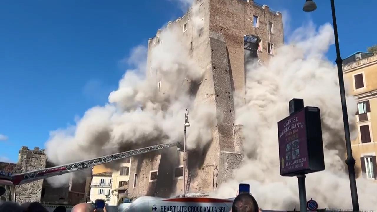 Rescuers work to reach worker trapped in medieval tower that partially ...